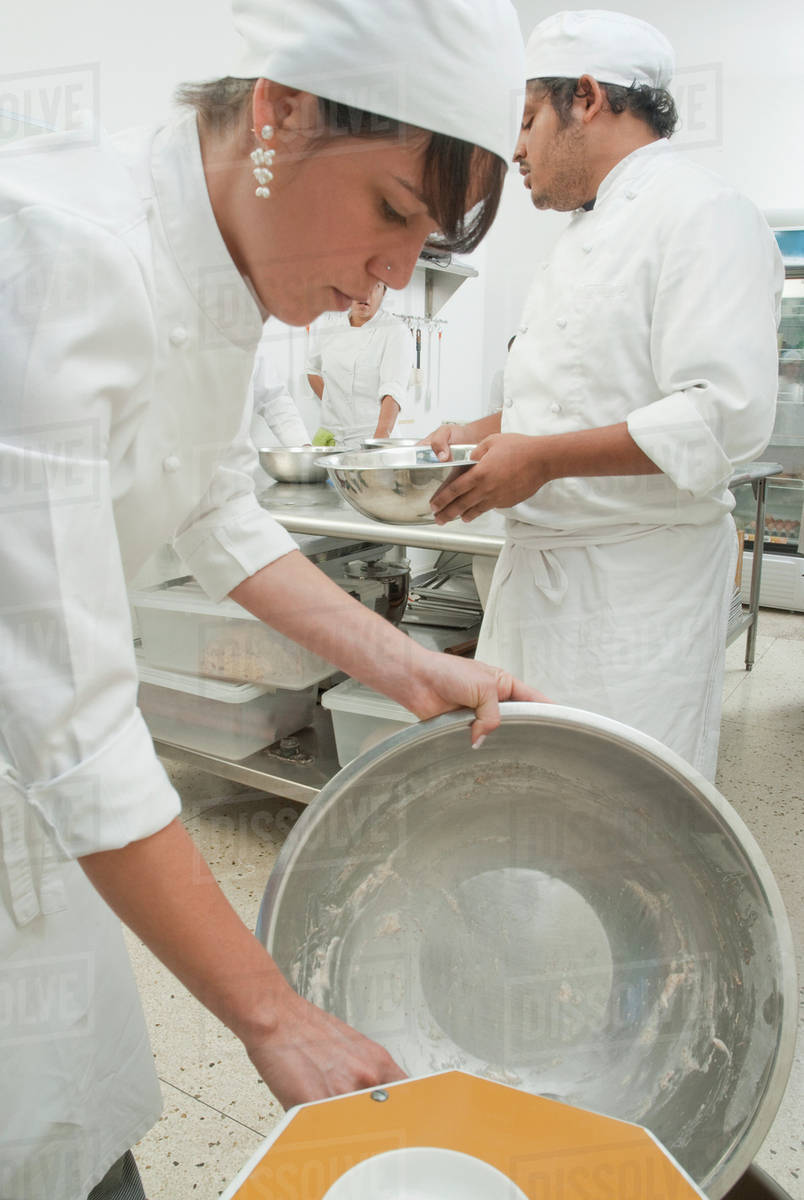 Bakers working in bakery kitchen - Royalty-free Stock Photo | Dissolve