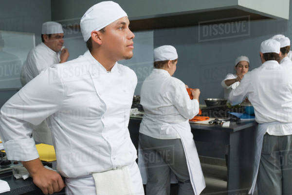 Bakers working in bakery kitchen - Royalty-free Stock Photo | Dissolve