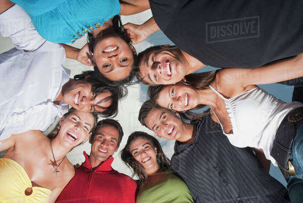 Smiling friends in huddle together - Royalty-free Stock Photo | Dissolve