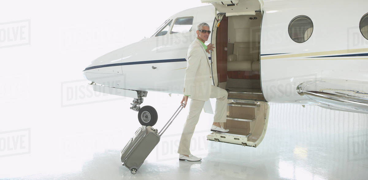Middle-aged man boarding airplane in hanger - Royalty-free Stock Photo ...