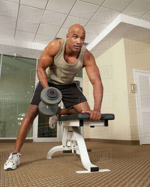 Mixed Race man lifting weights - Stock Photo - Dissolve