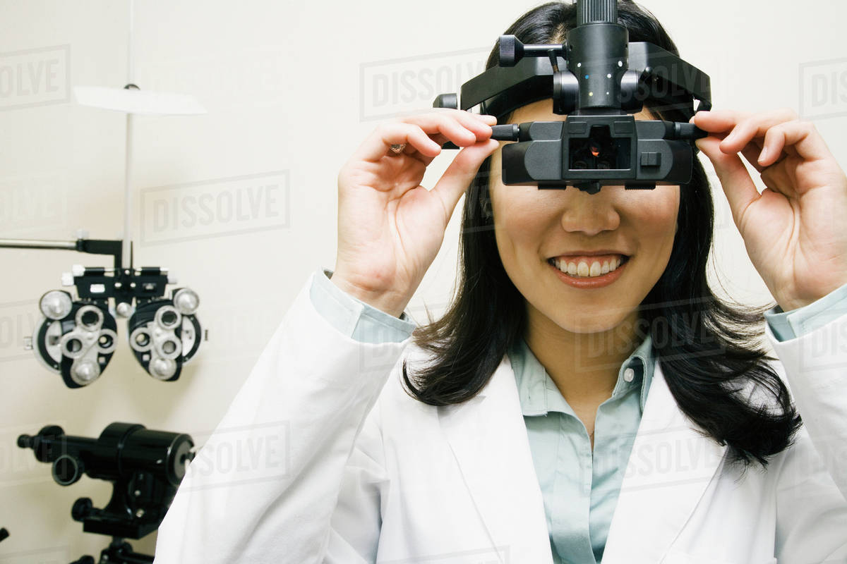 Asian female optometrist wearing examination equipment - Stock Photo ...