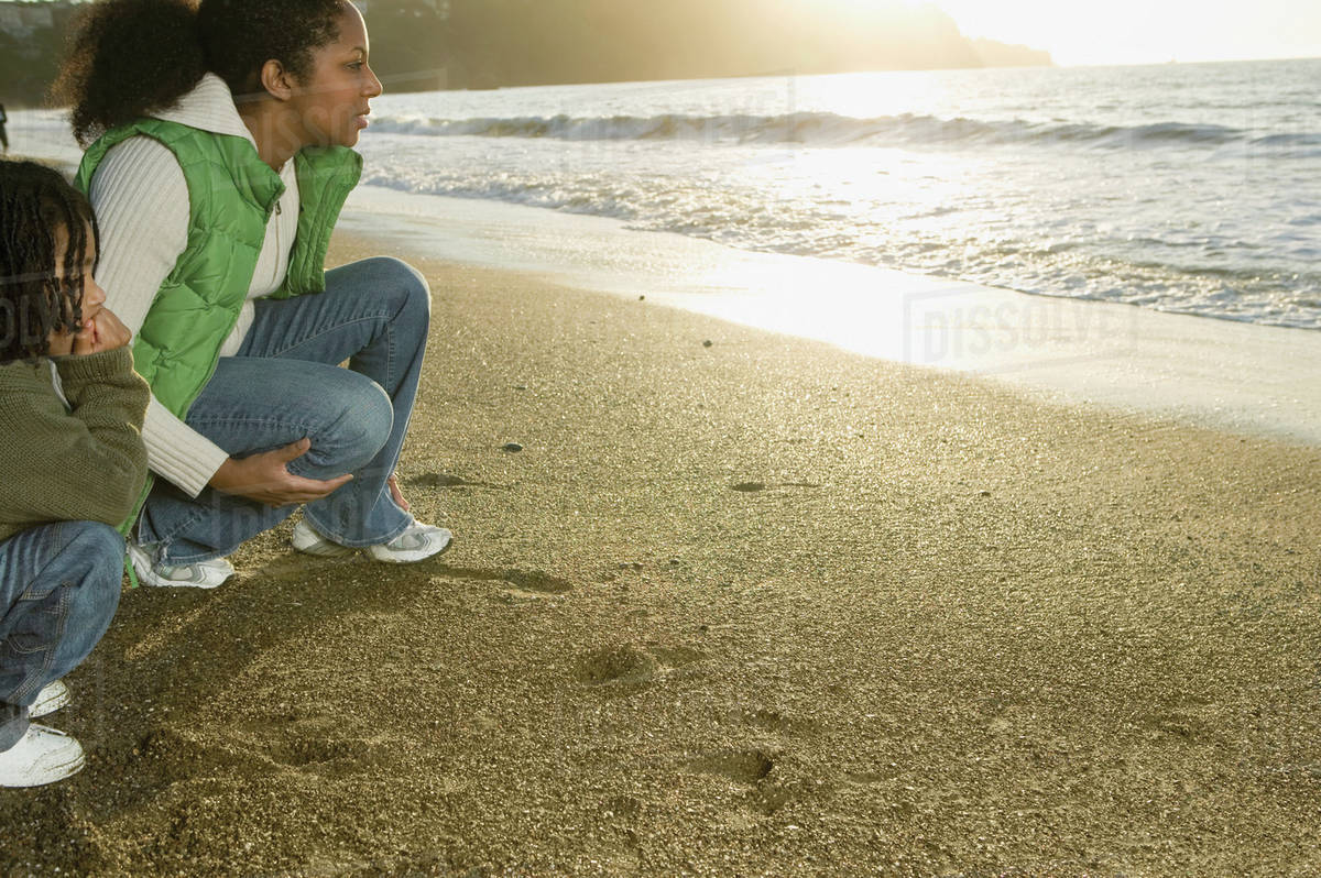 Mother and son sitting at the beach - Stock Photo - Dissolve