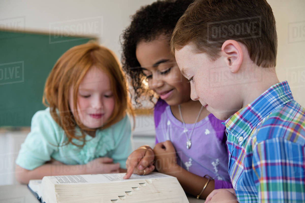 Students using dictionary in classroom - Royalty-free Stock Photo ...