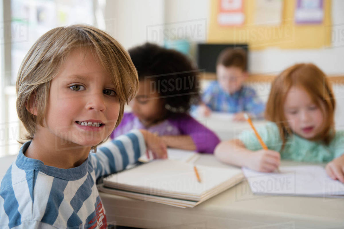 Student smiling in classroom - Royalty-free Stock Photo | Dissolve
