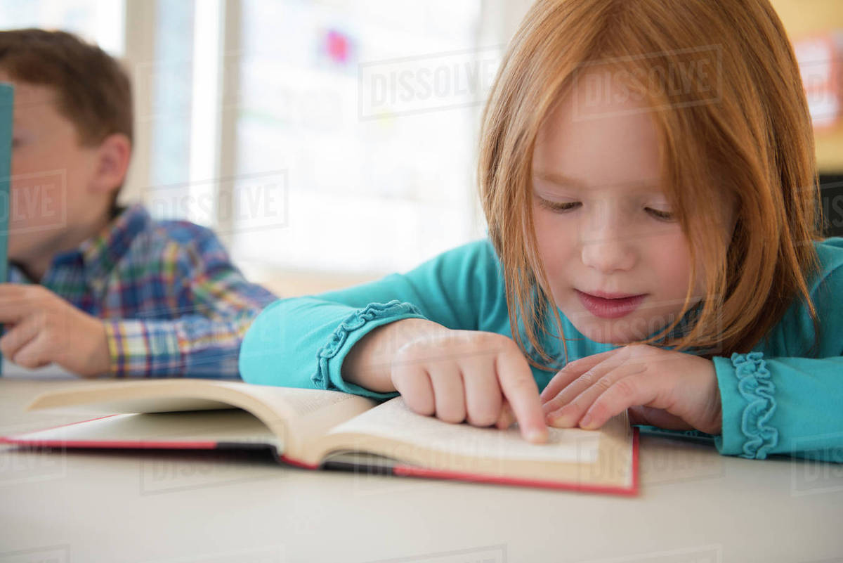 Caucasian student reading in classroom - Royalty-free Stock Photo ...