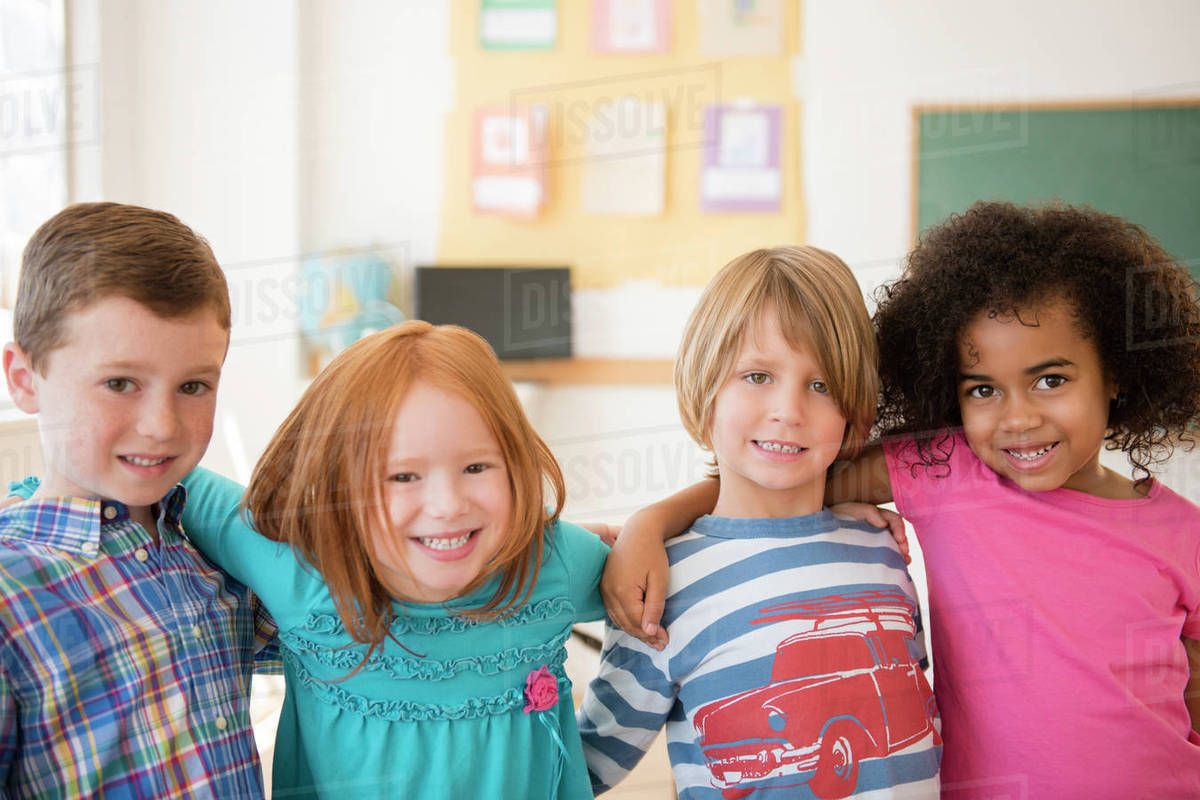 Students smiling in classroom - Royalty-free Stock Photo | Dissolve