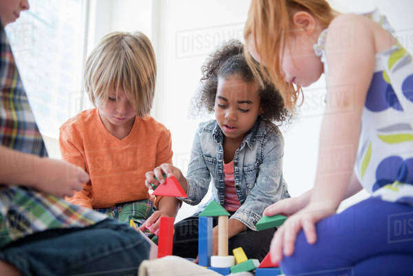 Children playing with blocks on floor - Royalty-free Stock Photo | Dissolve