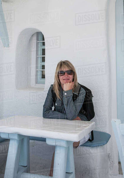 Caucasian woman sitting at table - Royalty-free Stock Photo | Dissolve