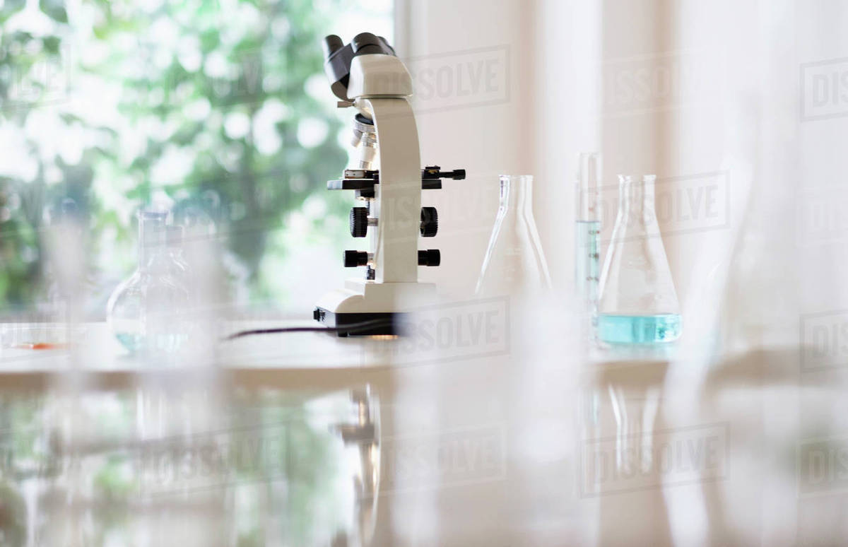 Microscope and beakers in laboratory - Royalty-free Stock Photo | Dissolve