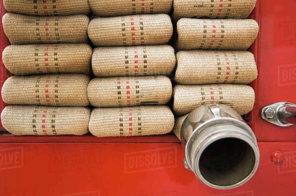 Close up of folded fire hose - Stock Photo - Dissolve