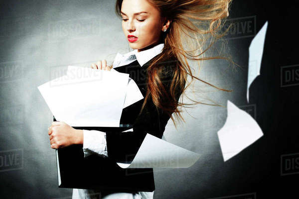 Caucasian teenage girl with windblown papers - Royalty-free Stock Photo ...