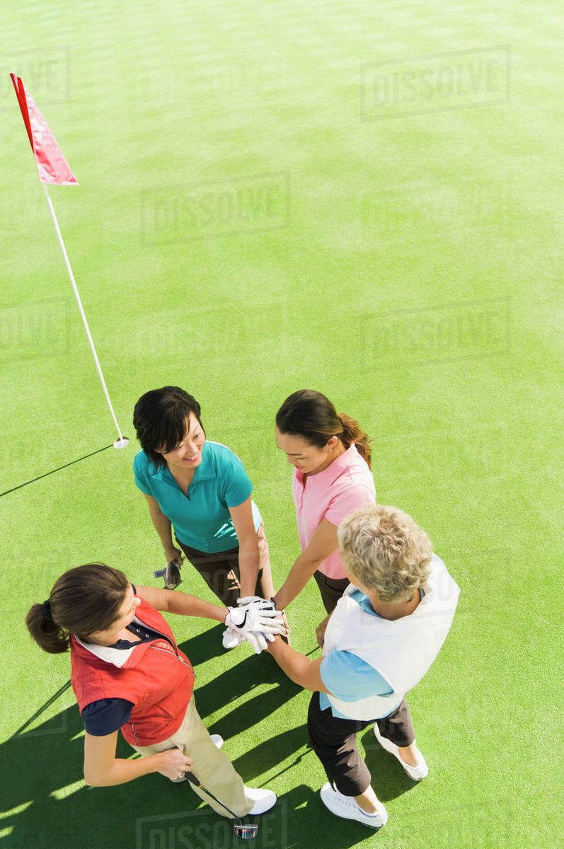 Women celebrating on golf course - Royalty-free Stock Photo | Dissolve