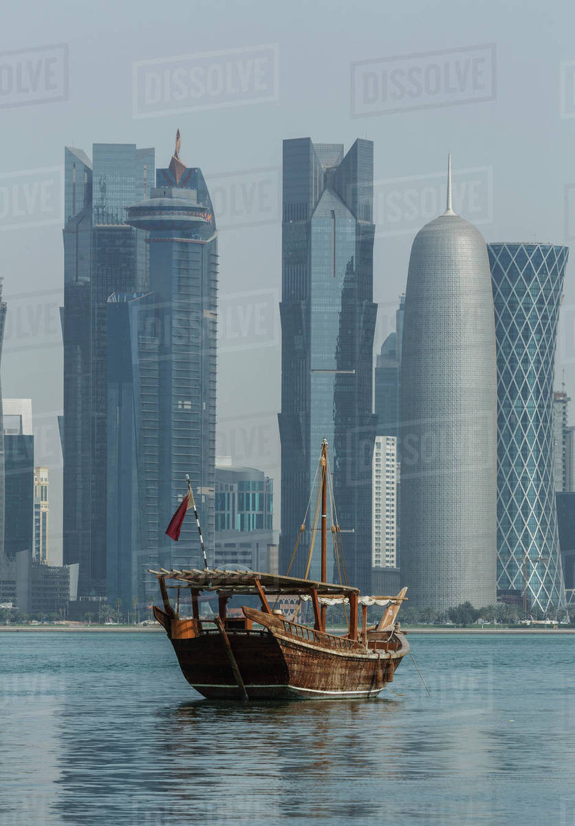 Boat floating near Doha skyline, Doha, Qatar - Stock Photo - Dissolve