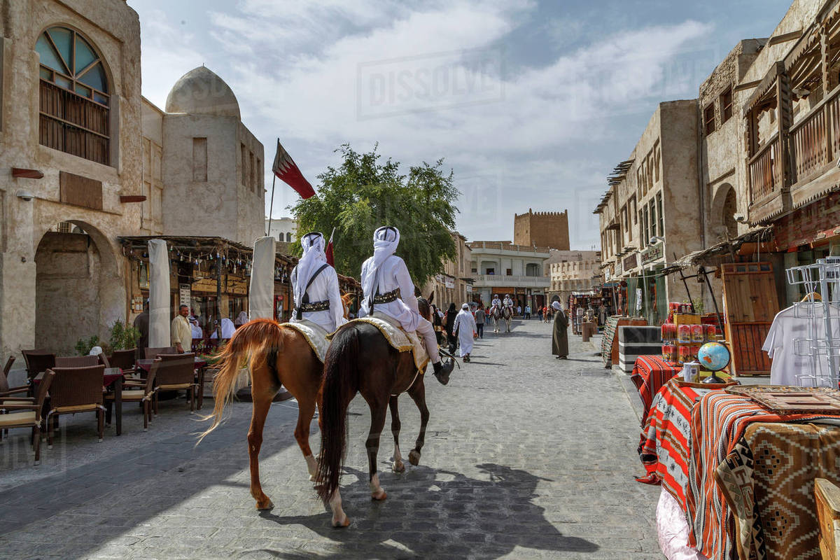 Men riding horses on Doha street, Doha, Qatar - Royalty-free Stock ...