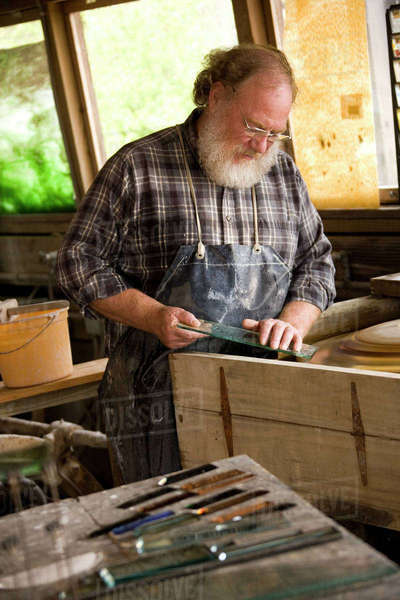 Caucasian craftsman in workshop - Stock Photo - Dissolve