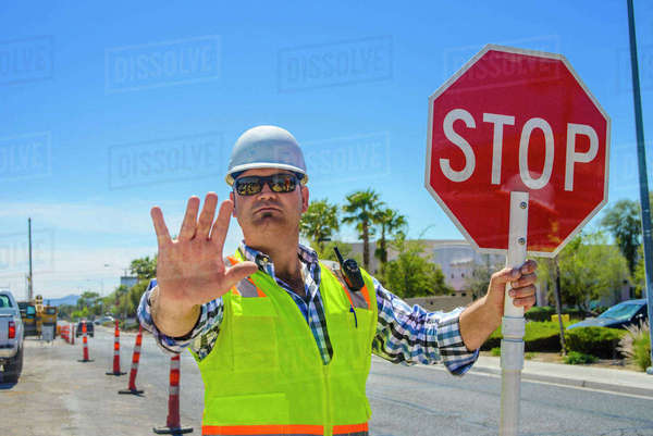 Caucasian flagger gesturing stop with stop sign - Royalty-free Stock ...