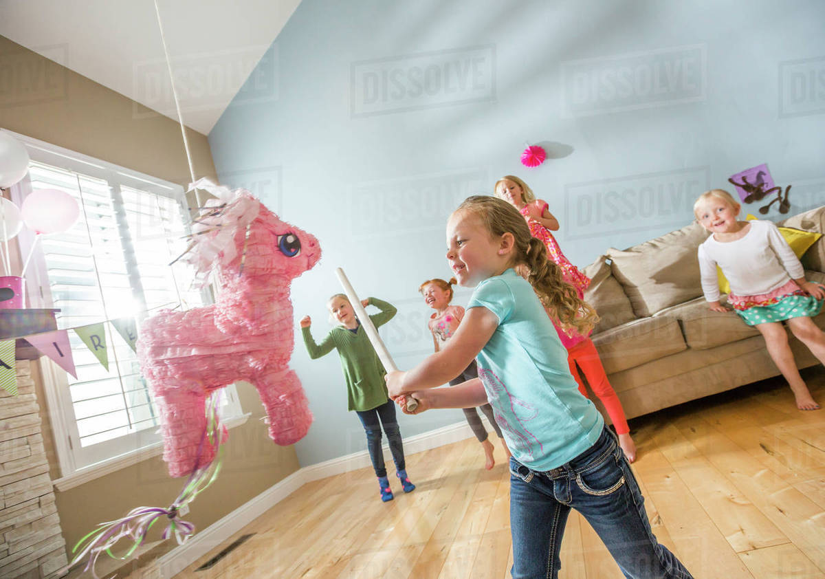 Caucasian girl hitting pinata at party - Royalty-free Stock Photo ...