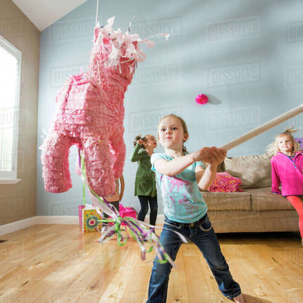 Caucasian girl hitting pinata at party - Royalty-free Stock Photo ...