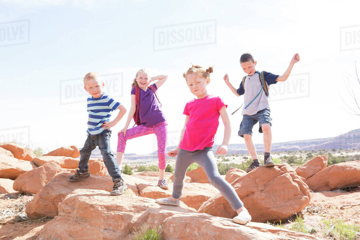 Caucasian boys and girls dancing on rocks - Royalty-free Stock Photo ...