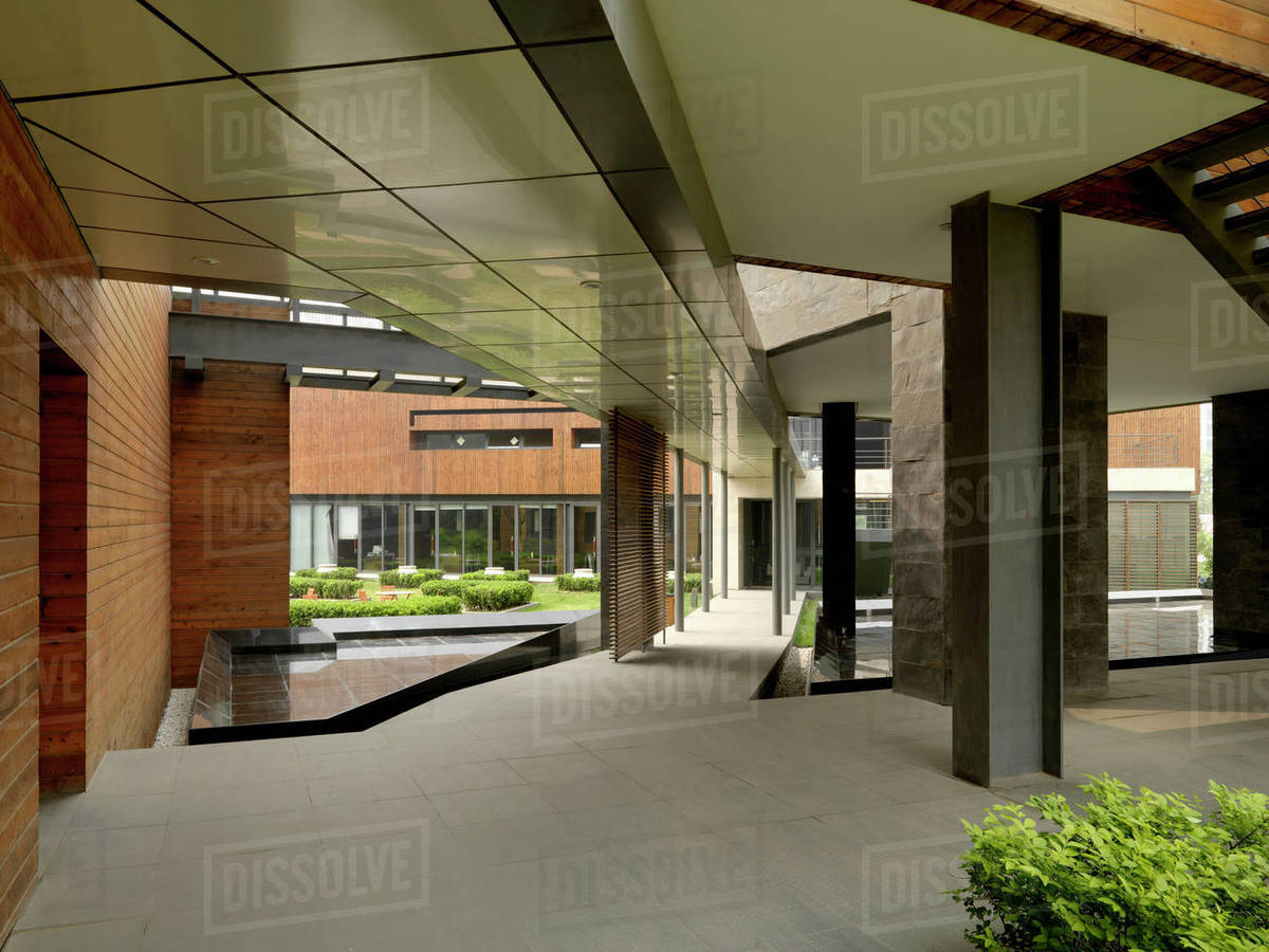 Walkway beneath modern building - Stock Photo - Dissolve