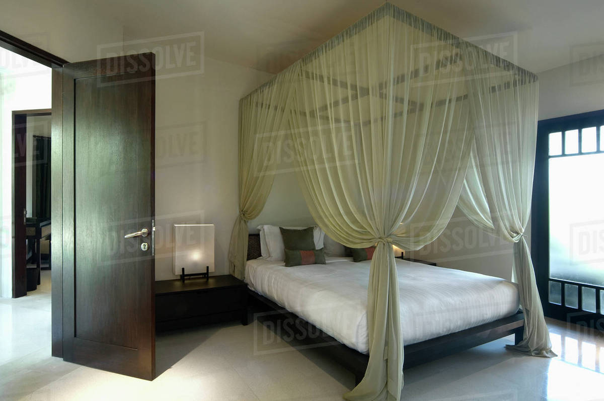 Master bedroom with bed drapes - Royalty-free Stock Photo | Dissolve