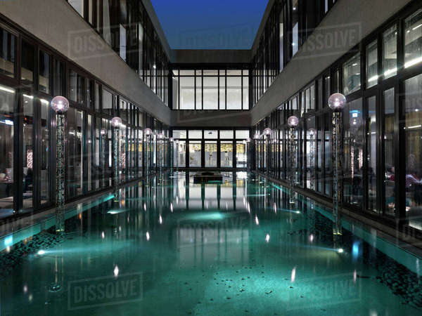 Reflection pool surrounded by modern glass building - Stock Photo ...