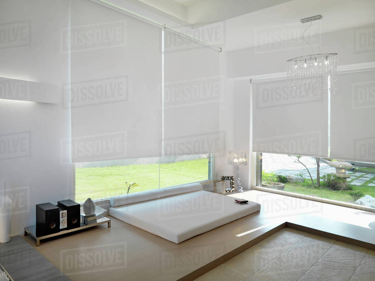 Spacious modern bedroom with large windows - Stock Photo - Dissolve