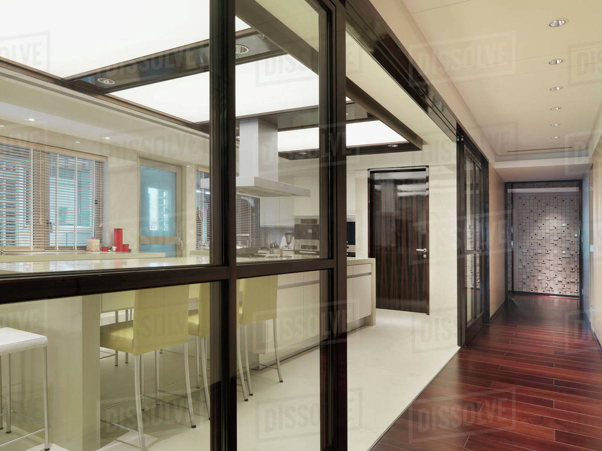Hardwood hallway along kitchen with pocket glass doors - Stock Photo ...