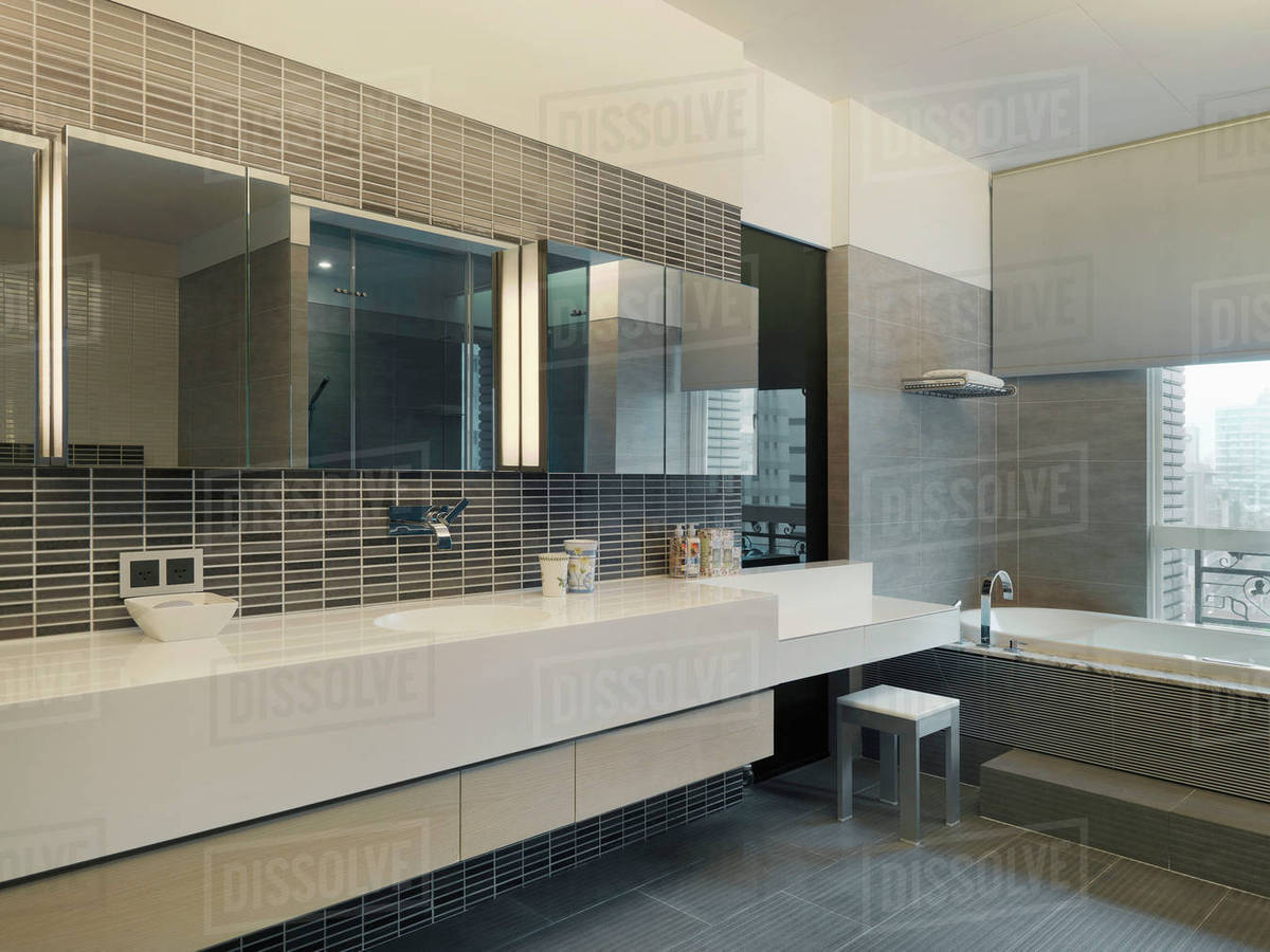 Modern bathroom with long countertop - Stock Photo - Dissolve
