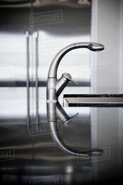 Detail of stainless steel faucet with reflection. - Stock Photo - Dissolve