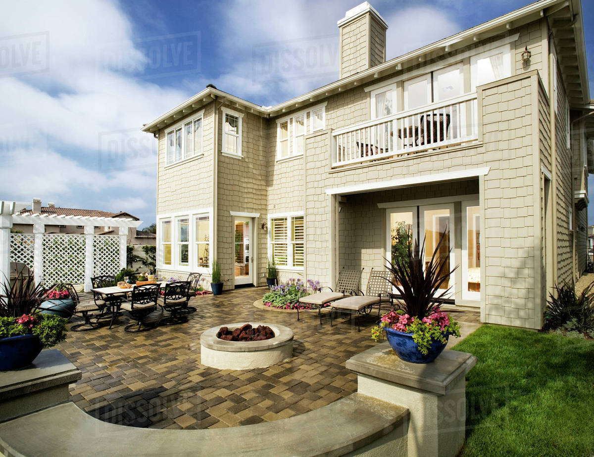 Rear exterior of residential building with seating area - Royalty-free ...