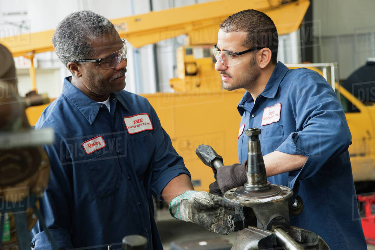 Mechanics working together - Royalty-free Stock Photo | Dissolve