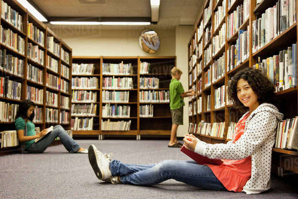 Children reading books in library - Royalty-free Stock Photo | Dissolve