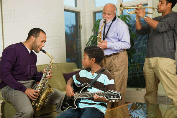 African American family playing musical instruments together - Royalty ...