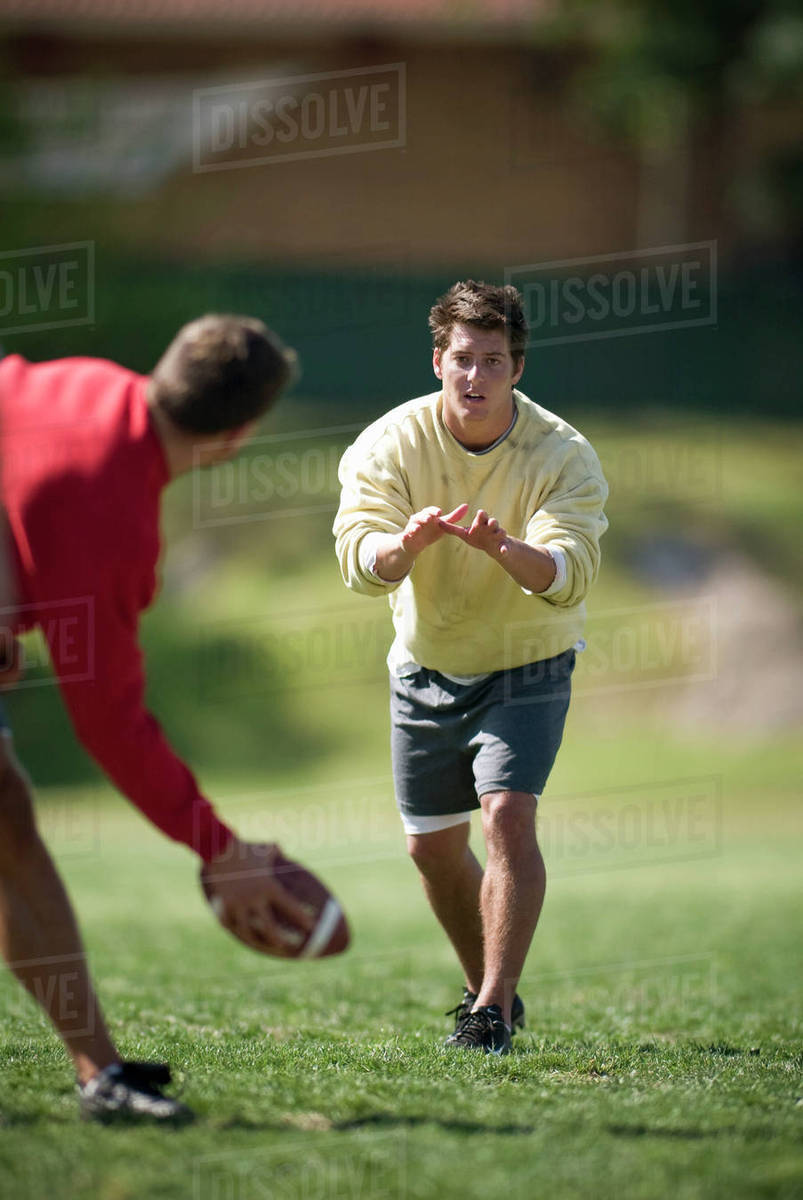 Men playing football - Royalty-free Stock Photo | Dissolve