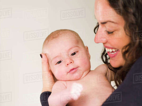Mother holding newborn baby - Royalty-free Stock Photo | Dissolve