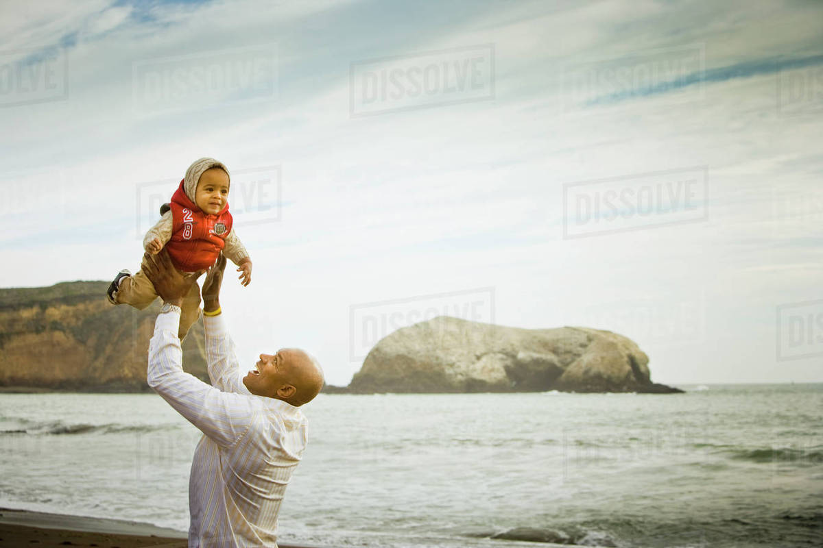 Father lifting baby son overhead at beach - Royalty-free Stock Photo ...