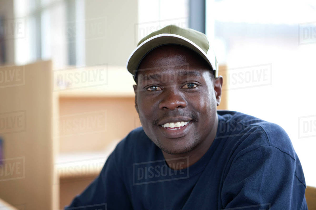 Smiling Black student in library - Royalty-free Stock Photo | Dissolve