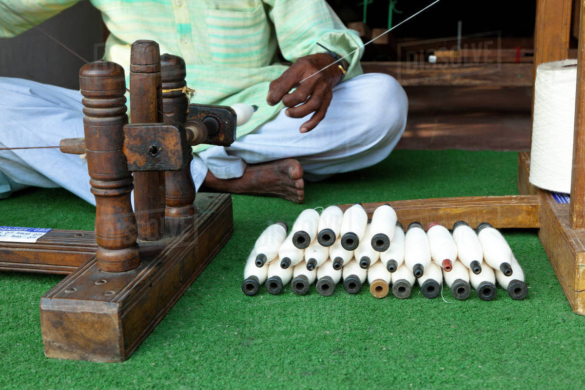 Indian man working with thread - Stock Photo - Dissolve