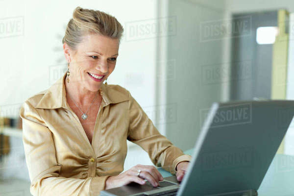 Caucasian woman typing on laptop - Royalty-free Stock Photo | Dissolve