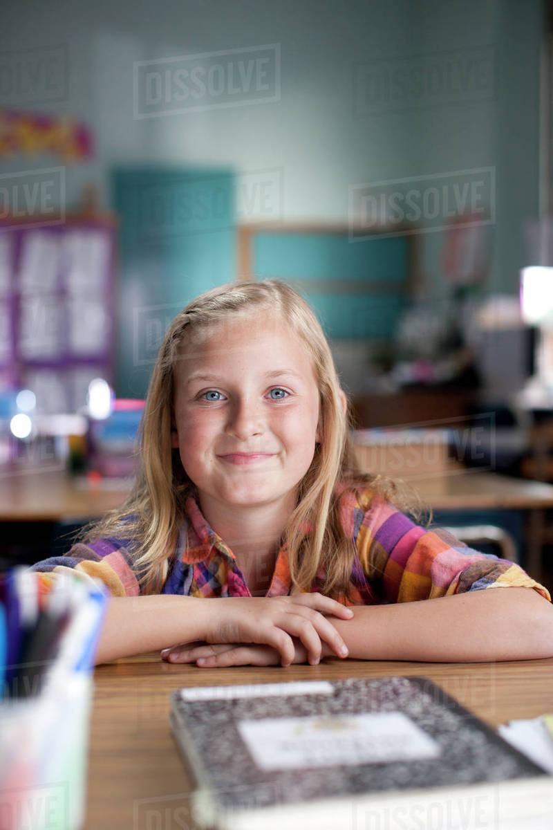 Caucasian girl sitting at desk in classroom - Royalty-free Stock Photo ...