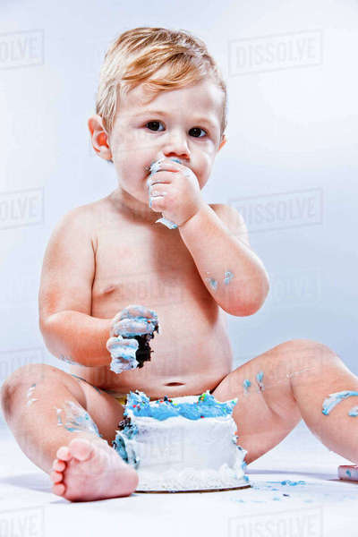 Caucasian baby eating birthday cake - Royalty-free Stock Photo | Dissolve