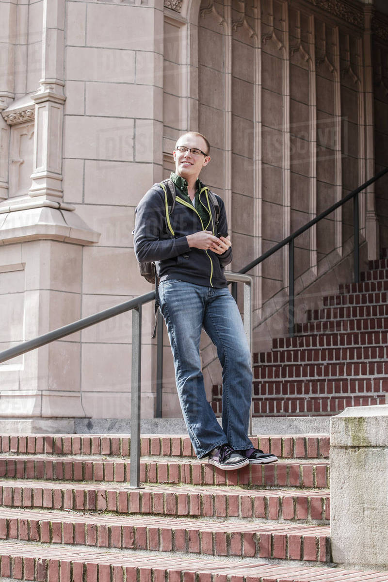 Caucasian student standing on campus staircase - Royalty-free Stock ...