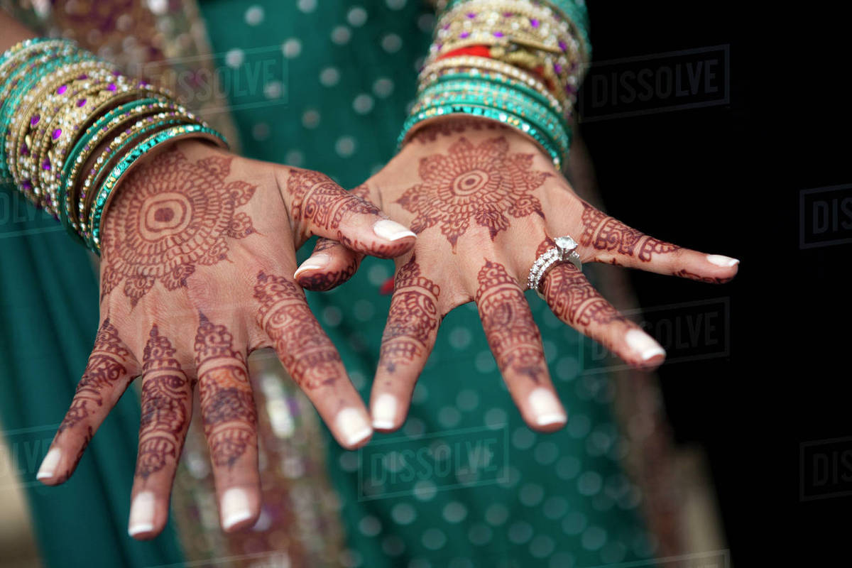 Close up of henna on Indian woman's hands - Stock Photo - Dissolve