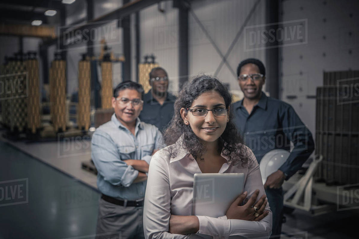 Workers standing together in factory - Stock Photo - Dissolve