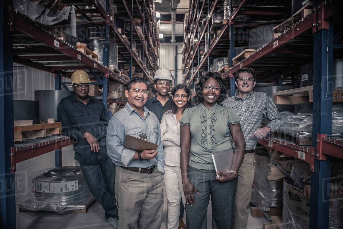 Workers standing together in factory - Stock Photo - Dissolve