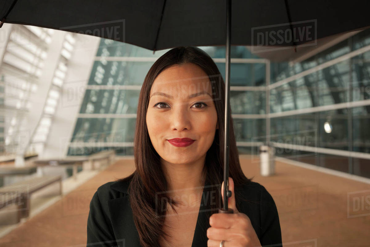 Asian businesswoman underneath umbrella - Royalty-free Stock Photo ...