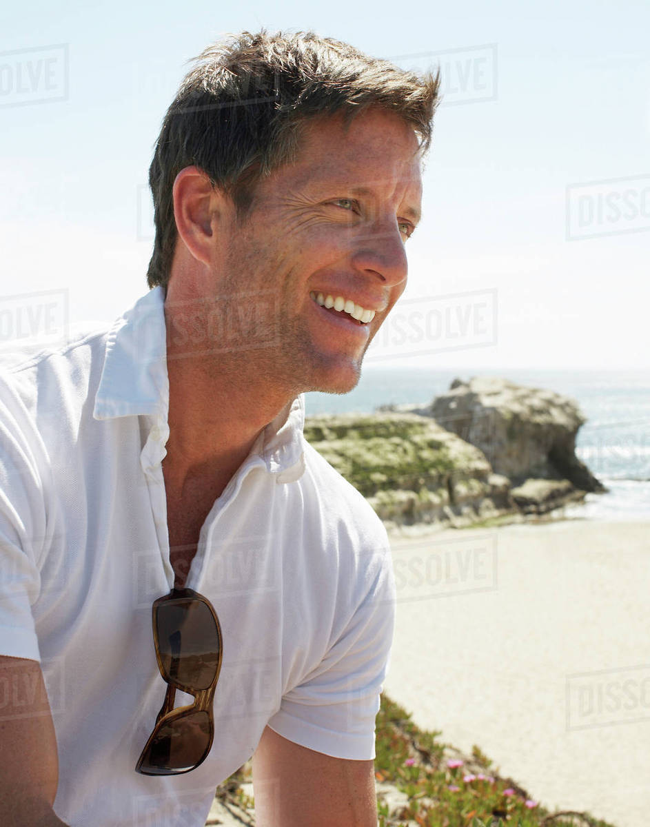 Smiling man enjoying beach - Stock Photo - Dissolve