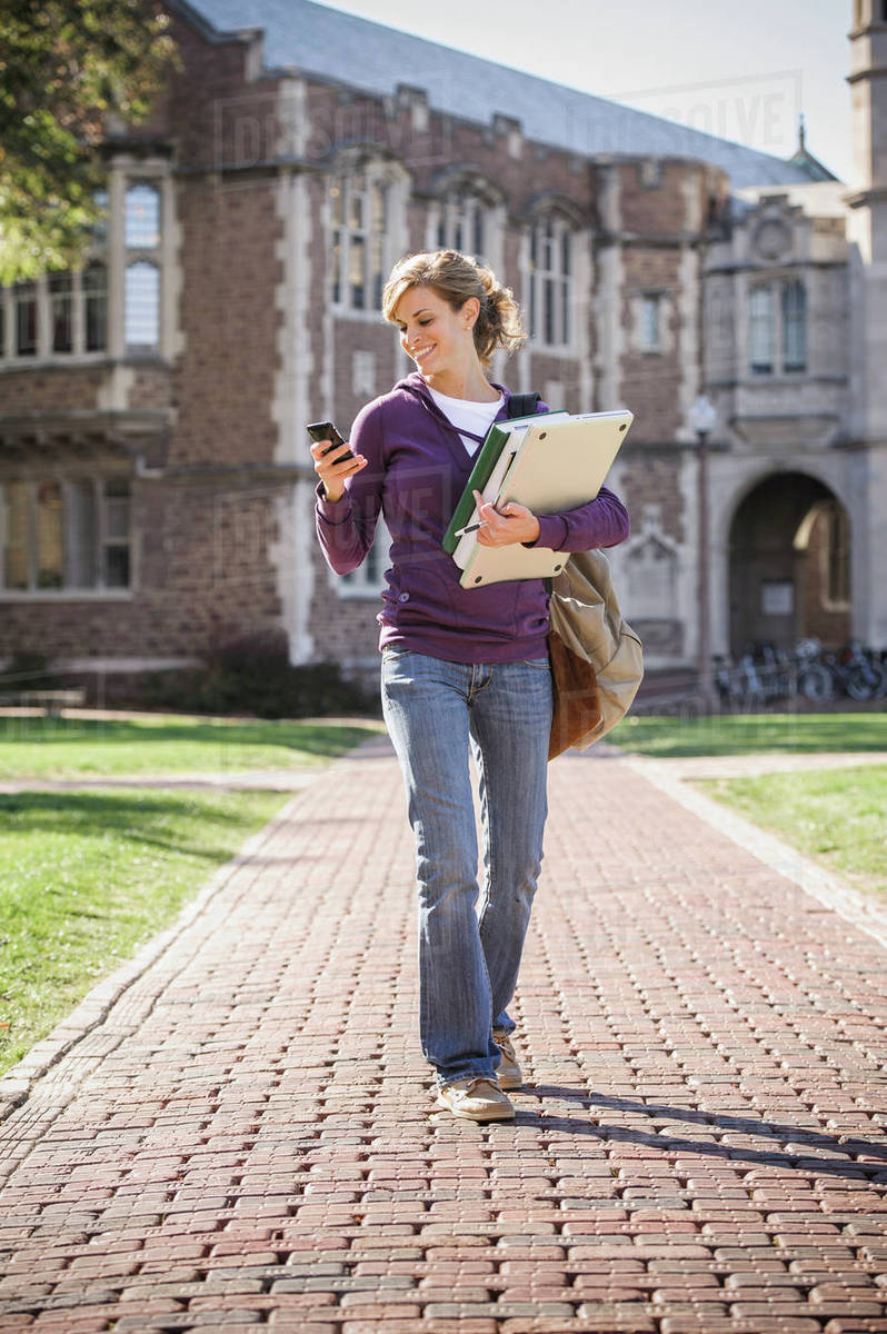 Caucasian student walking on campus - Royalty-free Stock Photo | Dissolve